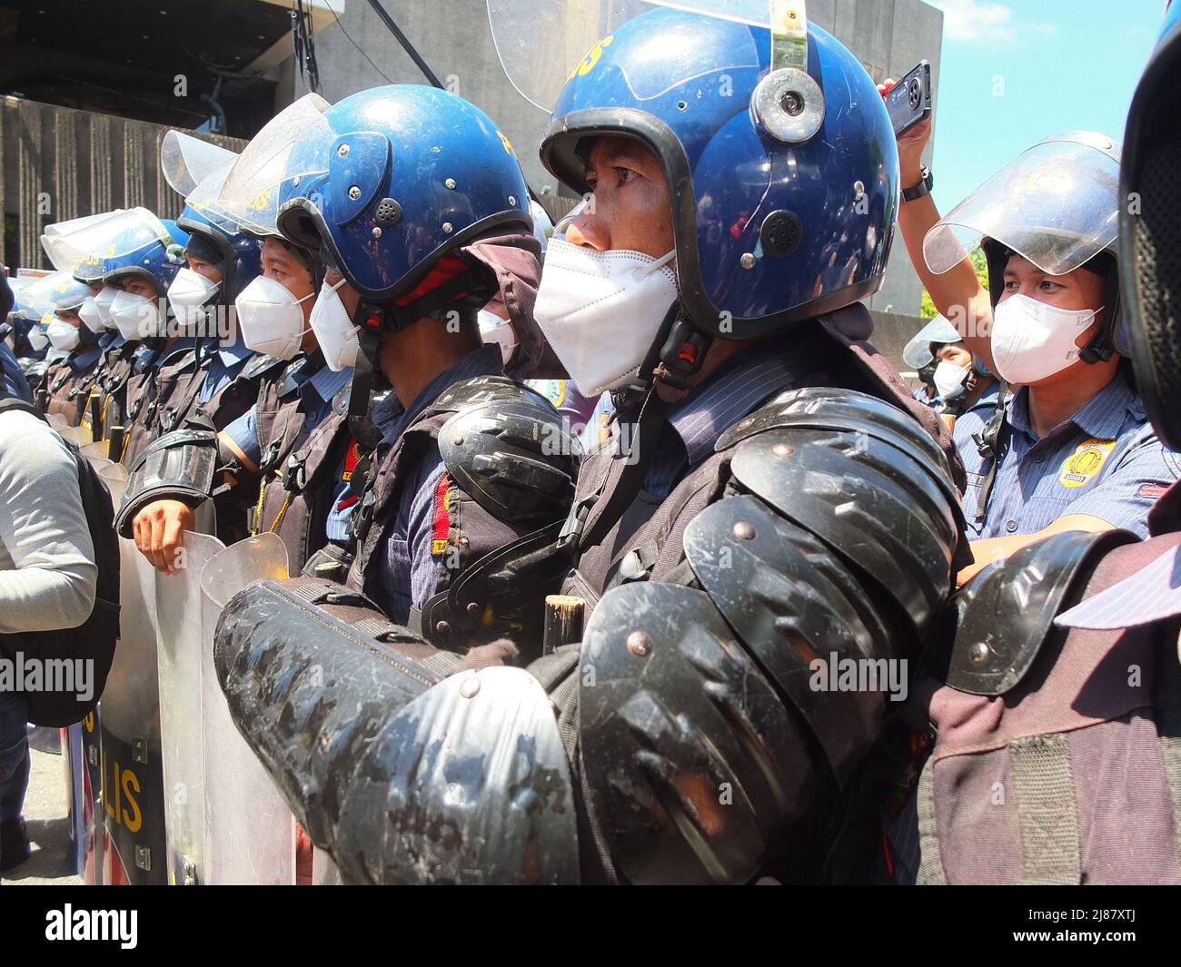 Members of the Civil Disturbance Management (CDM) Unit stand on guard ...