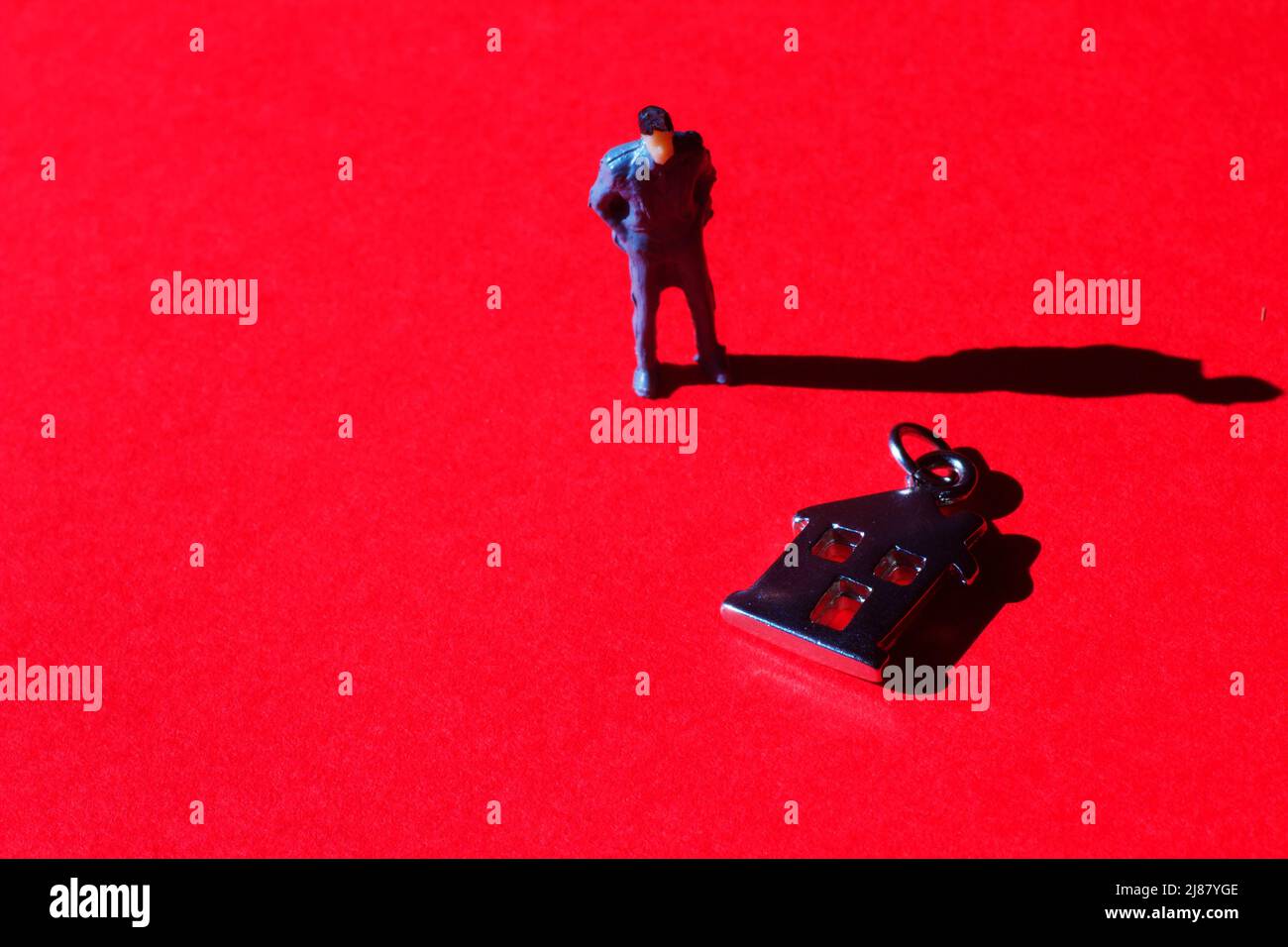 Miniature man watching a the house . Housing concept. Space for text ...