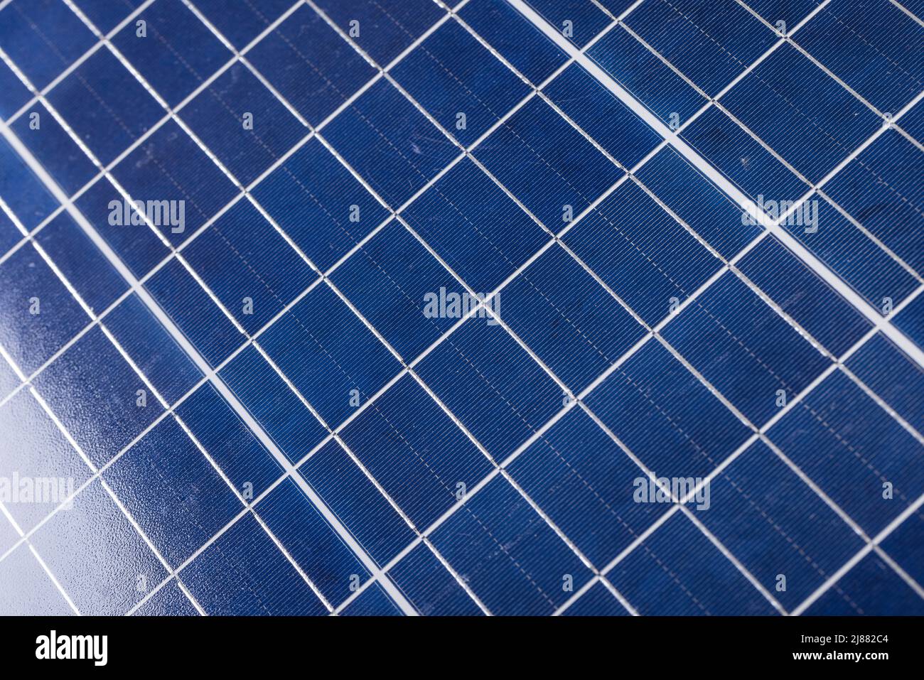 High angle full frame shot of white grid patterns on blue solar panel ...