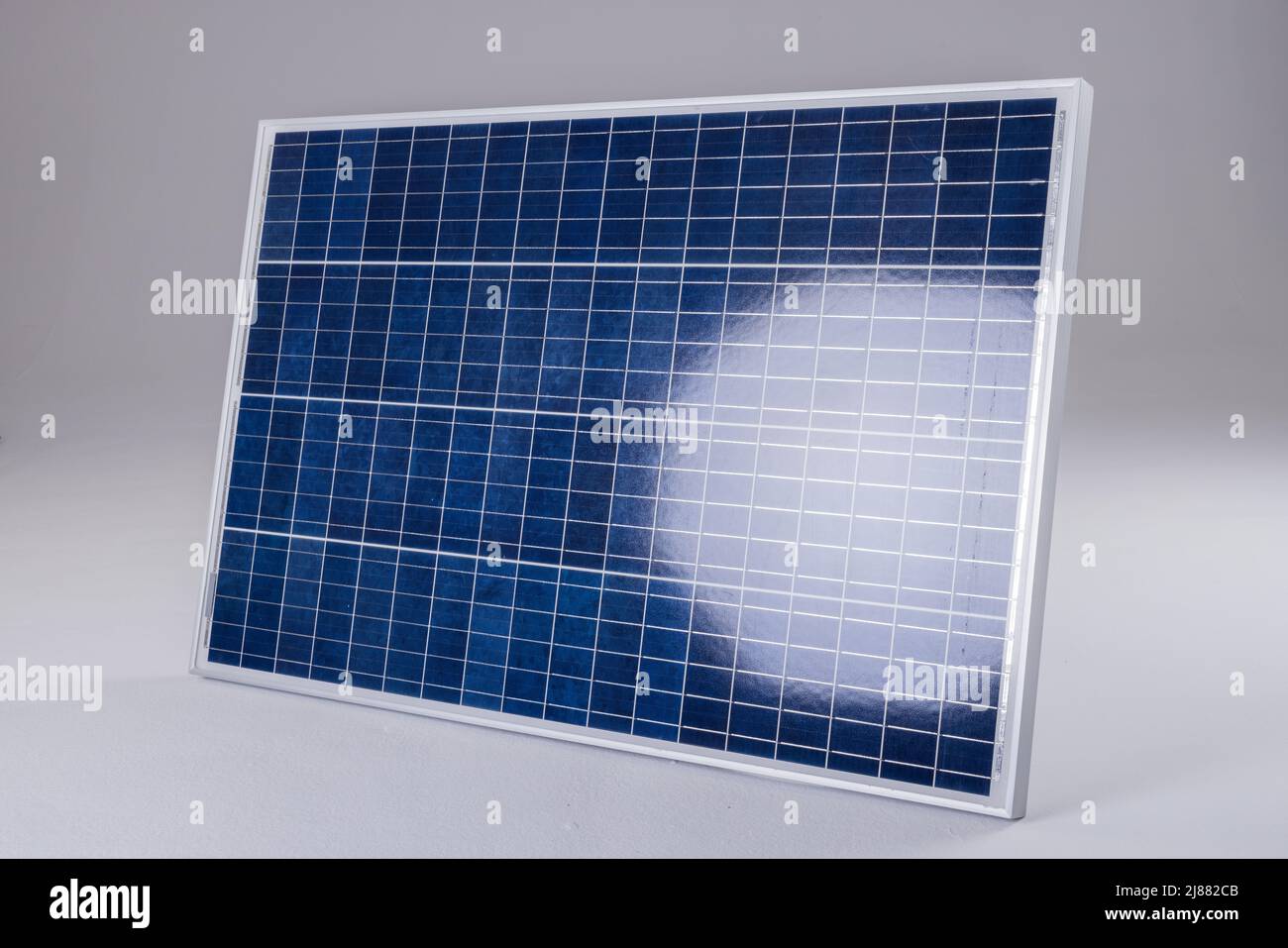 Sunlight reflecting on blue solar panel isolated against white ...