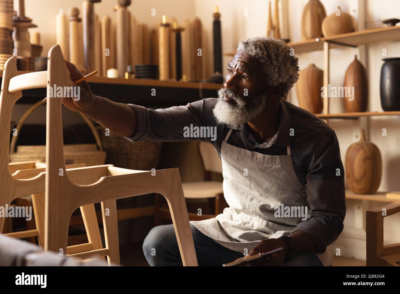 African american mature carpenter making chair in workshop Stock Photo ...