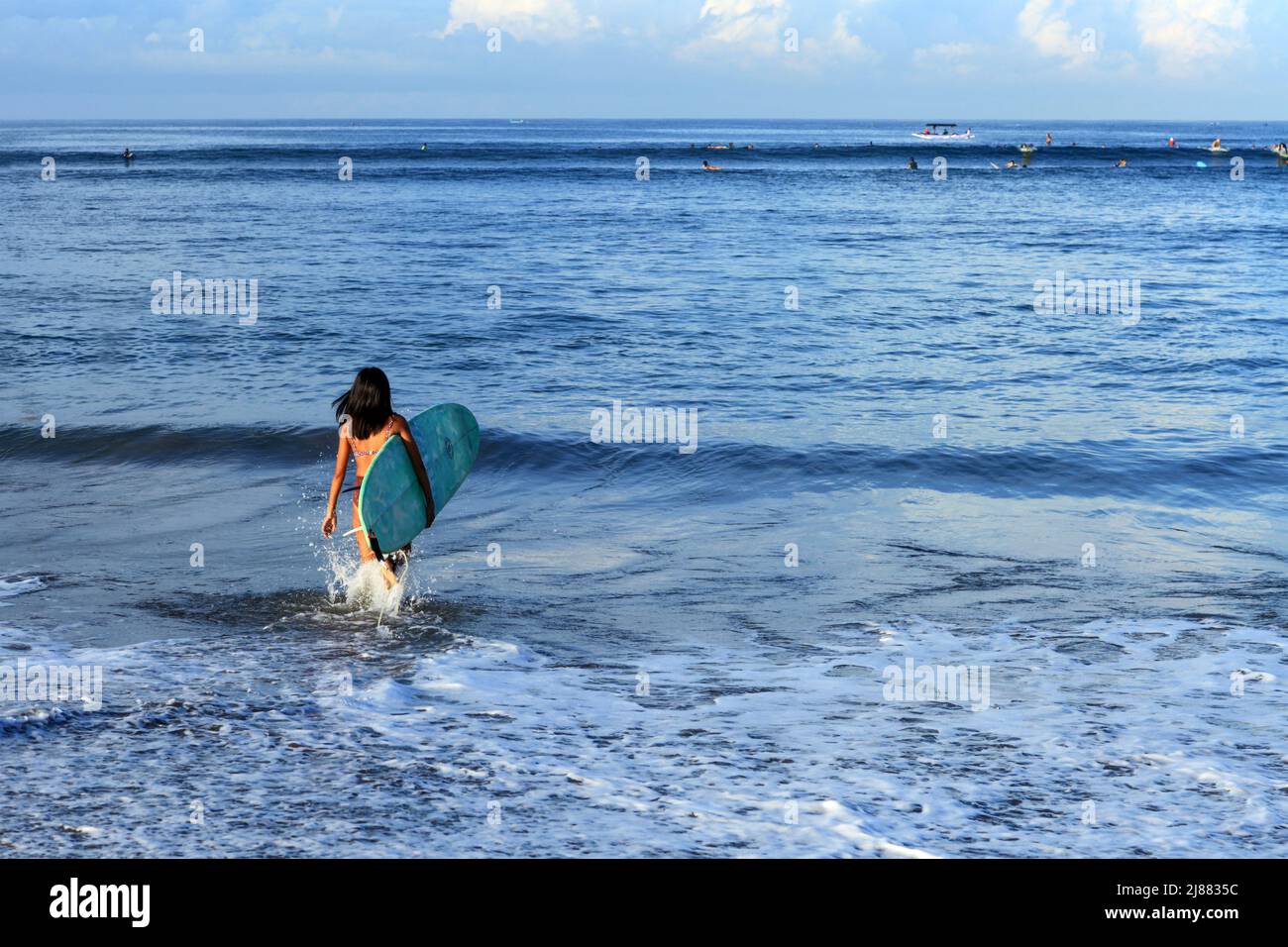 A young Indonesian Asian woman with long black hair wearing a brown ... A young Indonesian Asian woman with long black hair wearing a brown ...