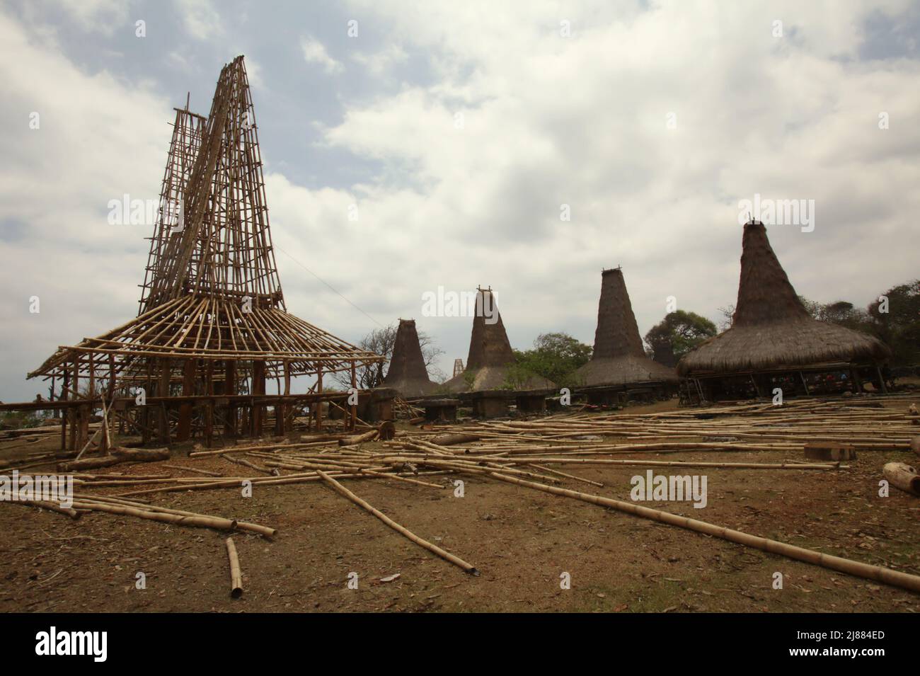 New Sumbanese traditional houses under construction, in a background of ...