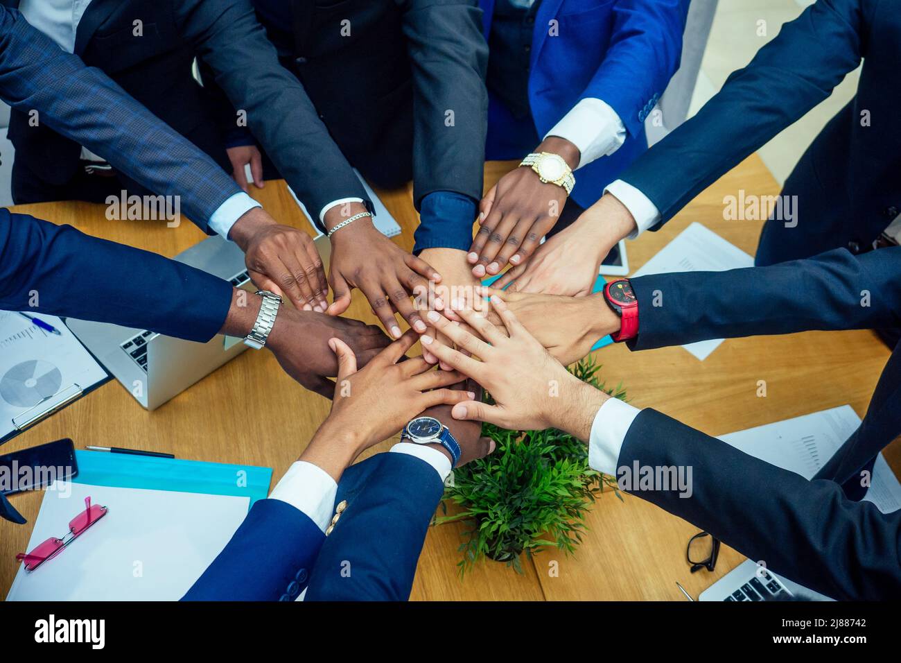 top view of team work high five a group of successful afro americans ...