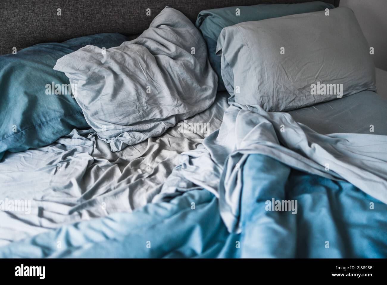 queen size bed lookng messy on one side and tidy on the other with ...