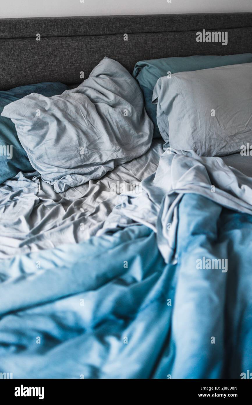 queen size bed lookng messy on one side and tidy on the other with ...