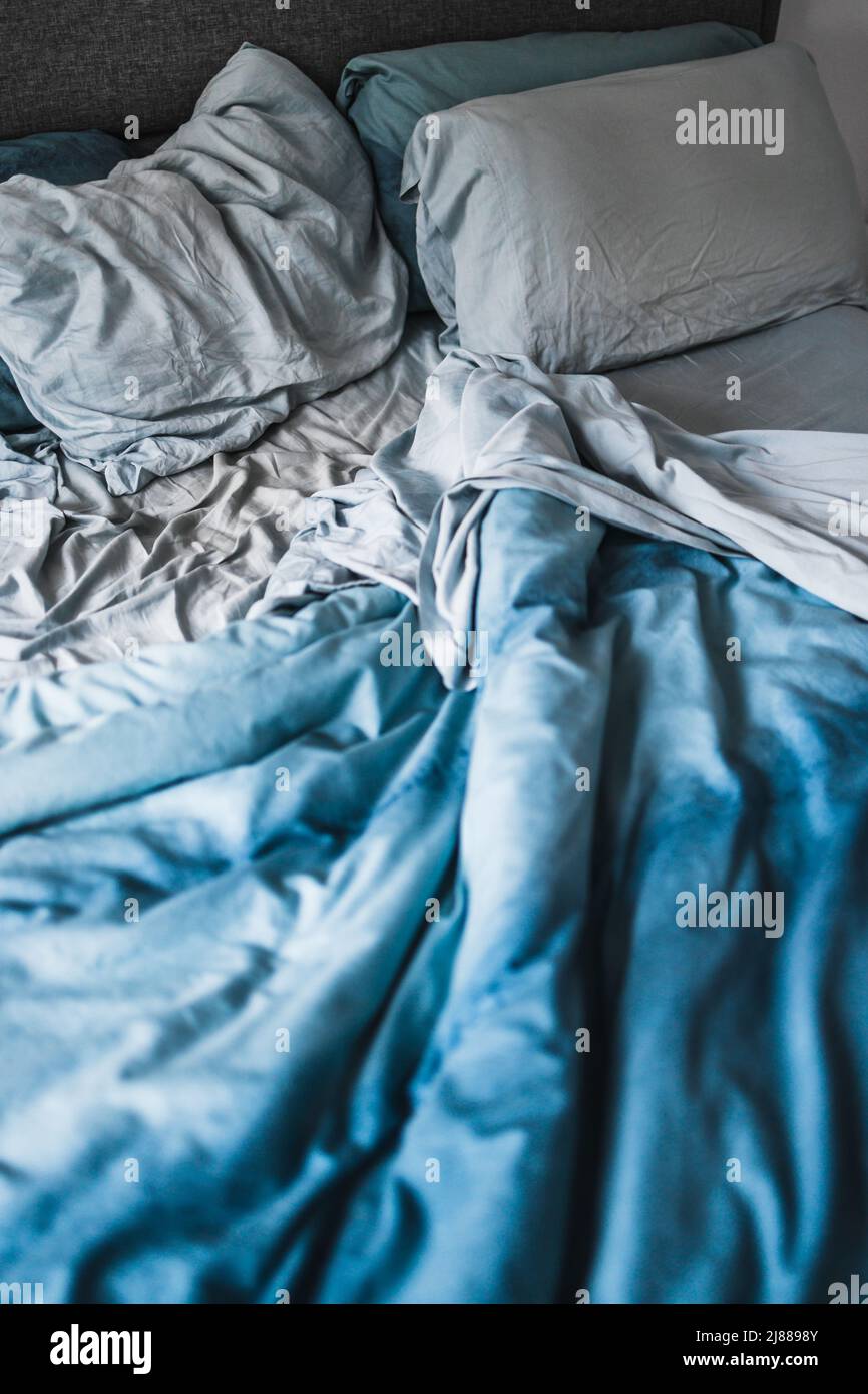 queen size bed lookng messy on one side and tidy on the other with ...