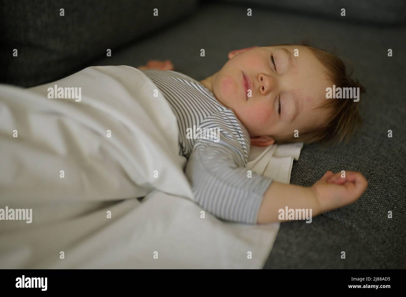 Sofa sleeping child hi-res stock photography and images - Alamy