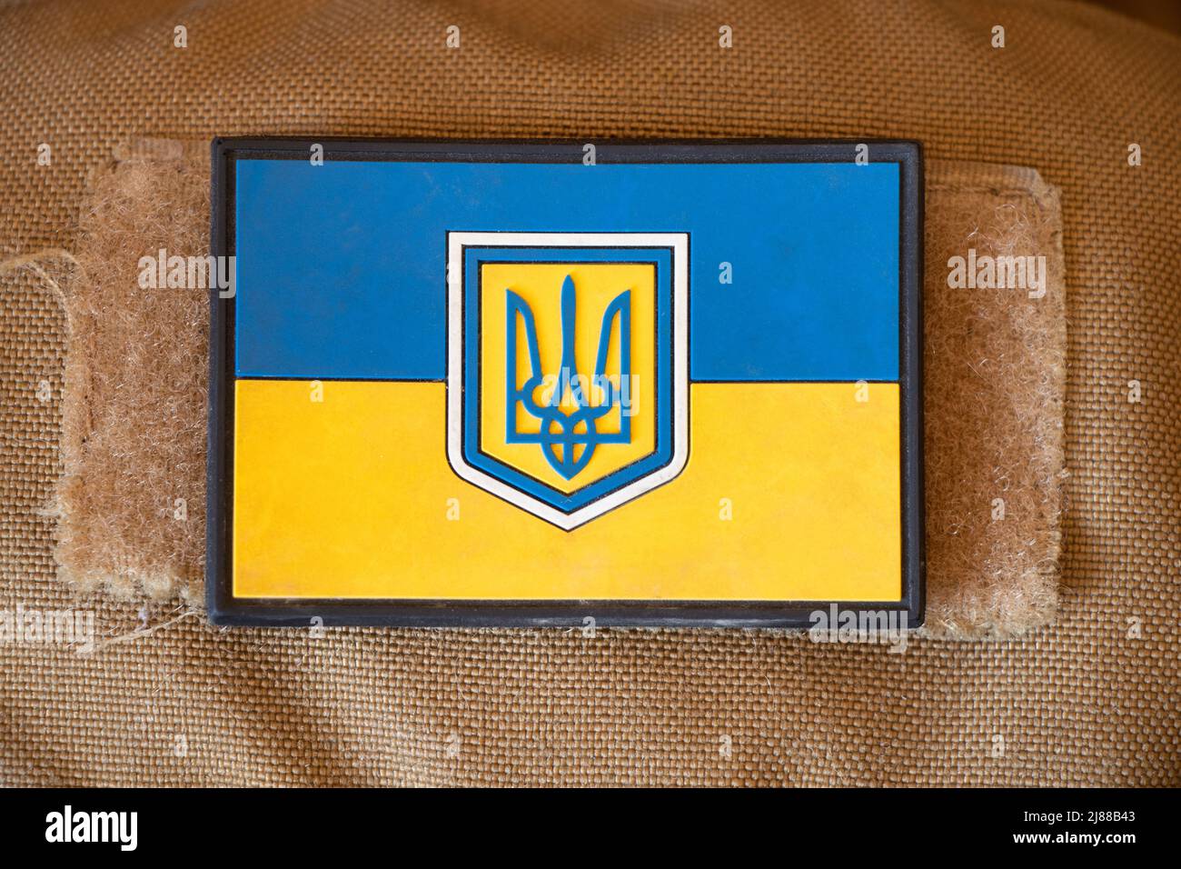 Yellow and blue national flag of Ukraine on the green uniform of a ...