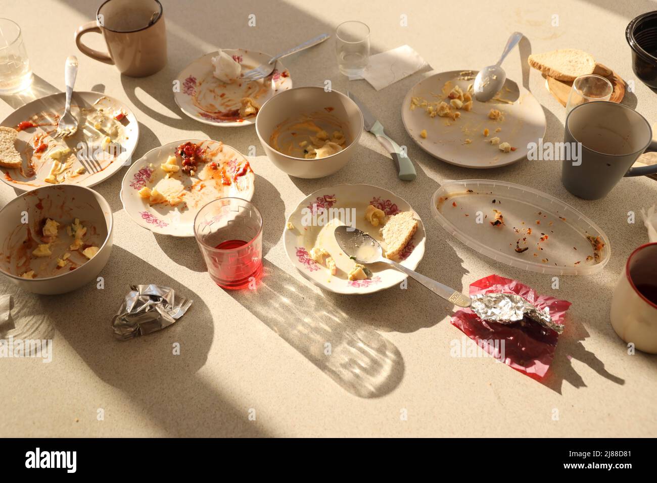 Empty dirty plates with spoons and forks on the table after meal ...