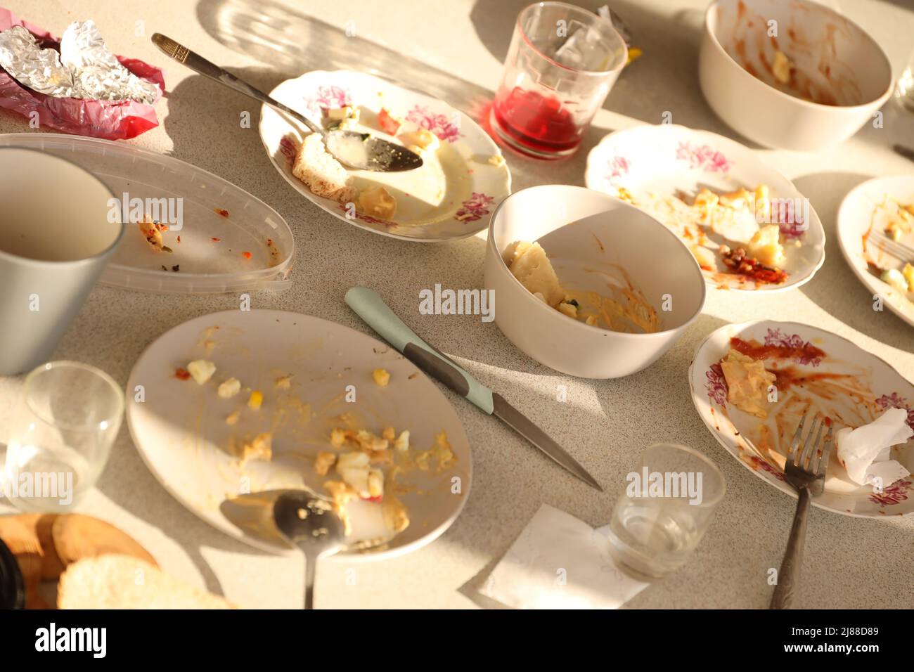 Empty dirty plates with spoons and forks on the table after meal ...