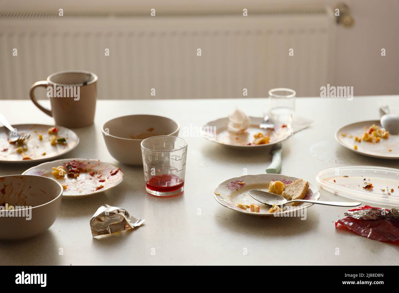 Empty dirty plates with spoons and forks on the table after meal ...