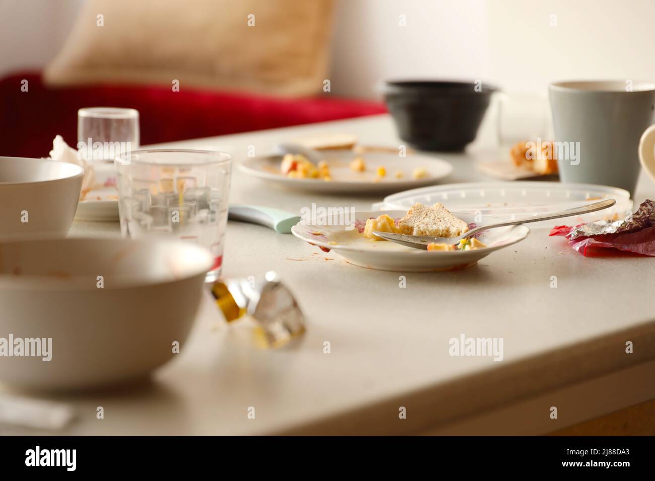 Empty dirty plates with spoons and forks on the table after meal ...
