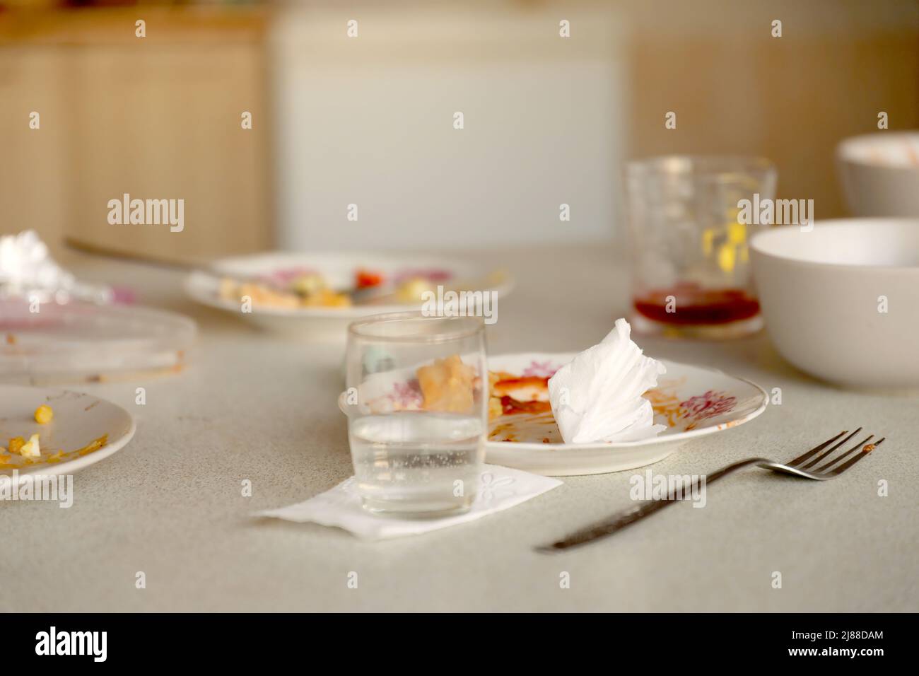 Empty dirty plates with spoons and forks on the table after meal ...