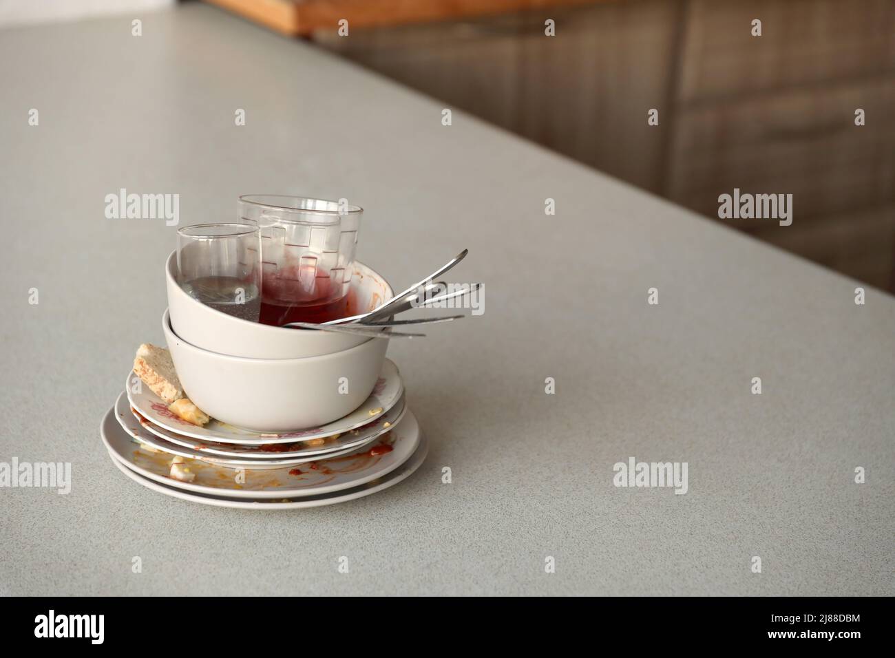 Stack of dirty dishes with food leftovers on the table after meal ...