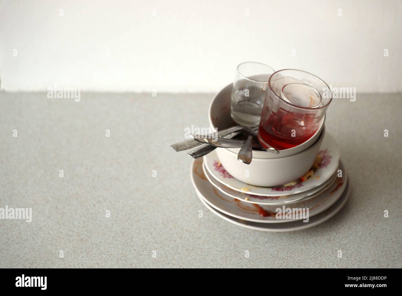 Stack of dirty dishes with food leftovers on the table after meal ...