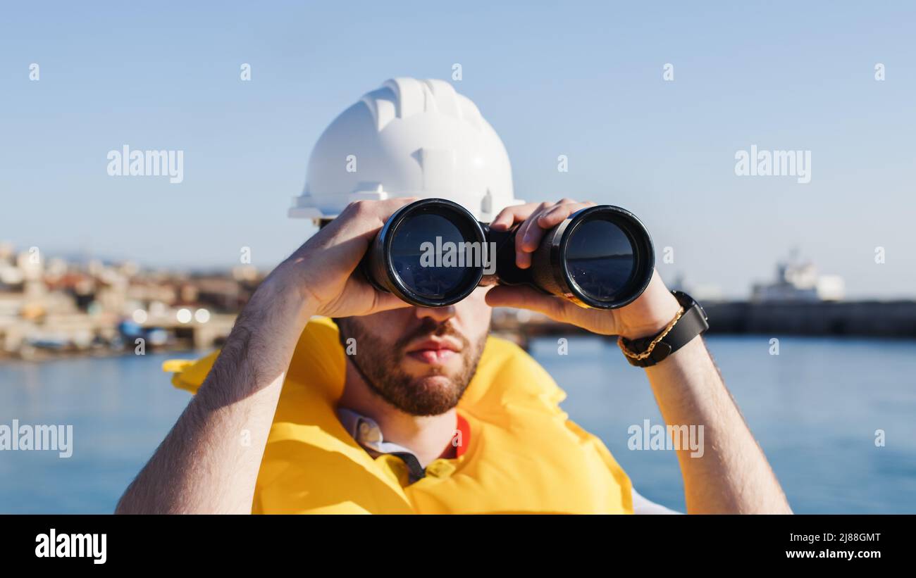 sailor watching with binoculars close up Stock Photo - Alamy