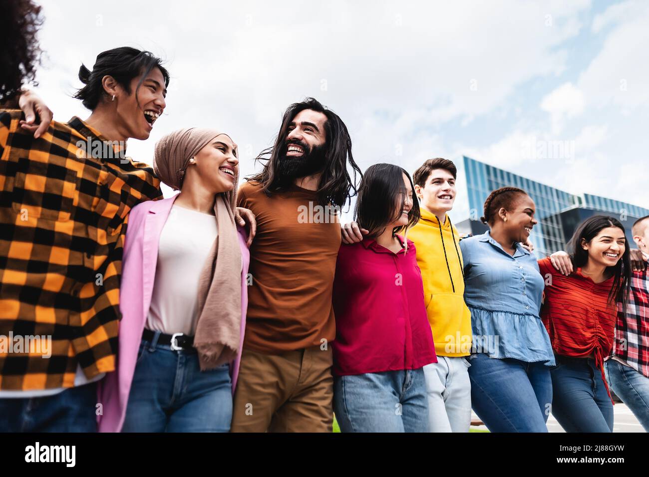Young multiracial friends having fun together hanging out in the city ...