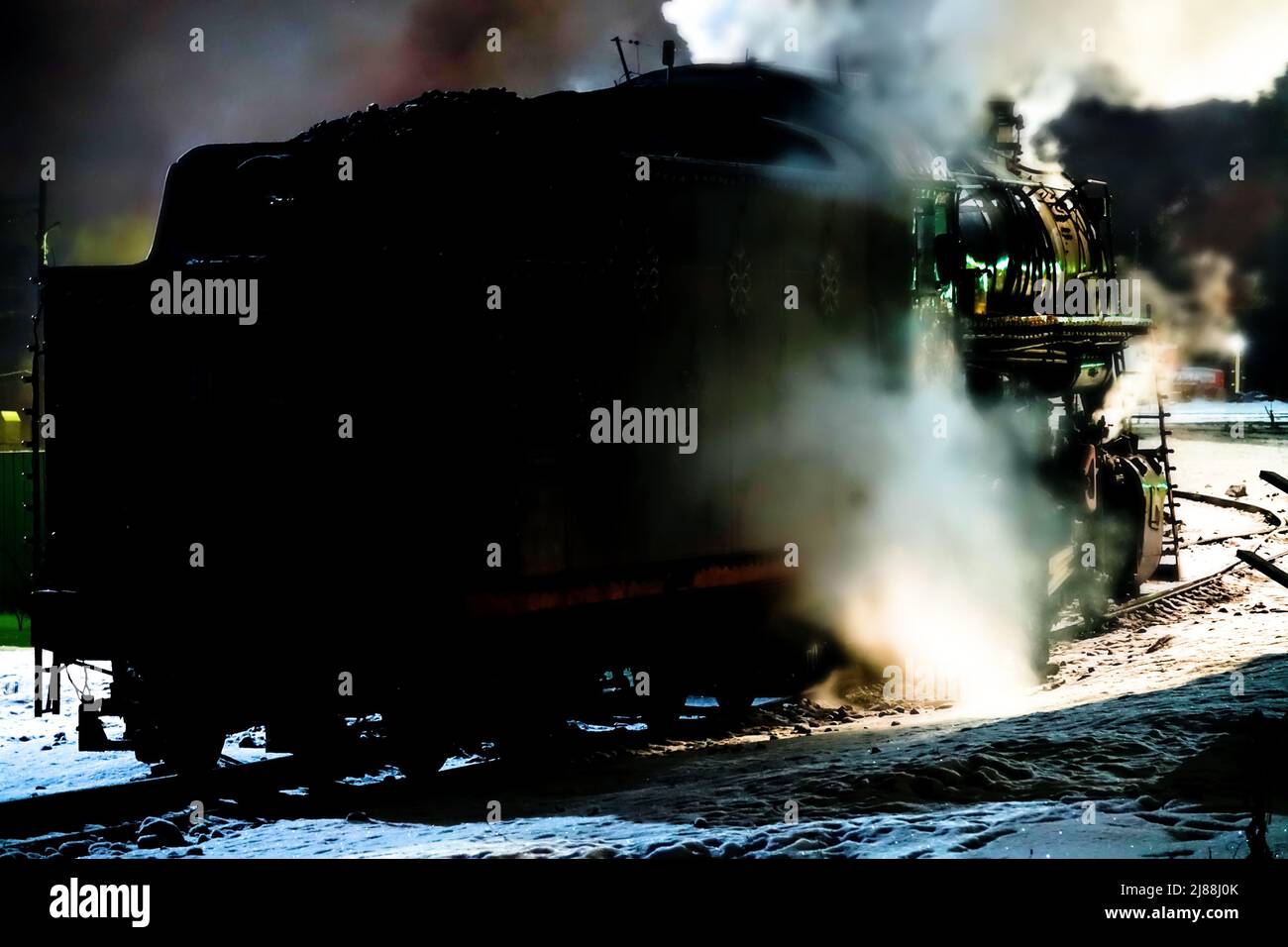 Steam locomotive under steam at winter night Stock Photo - Alamy