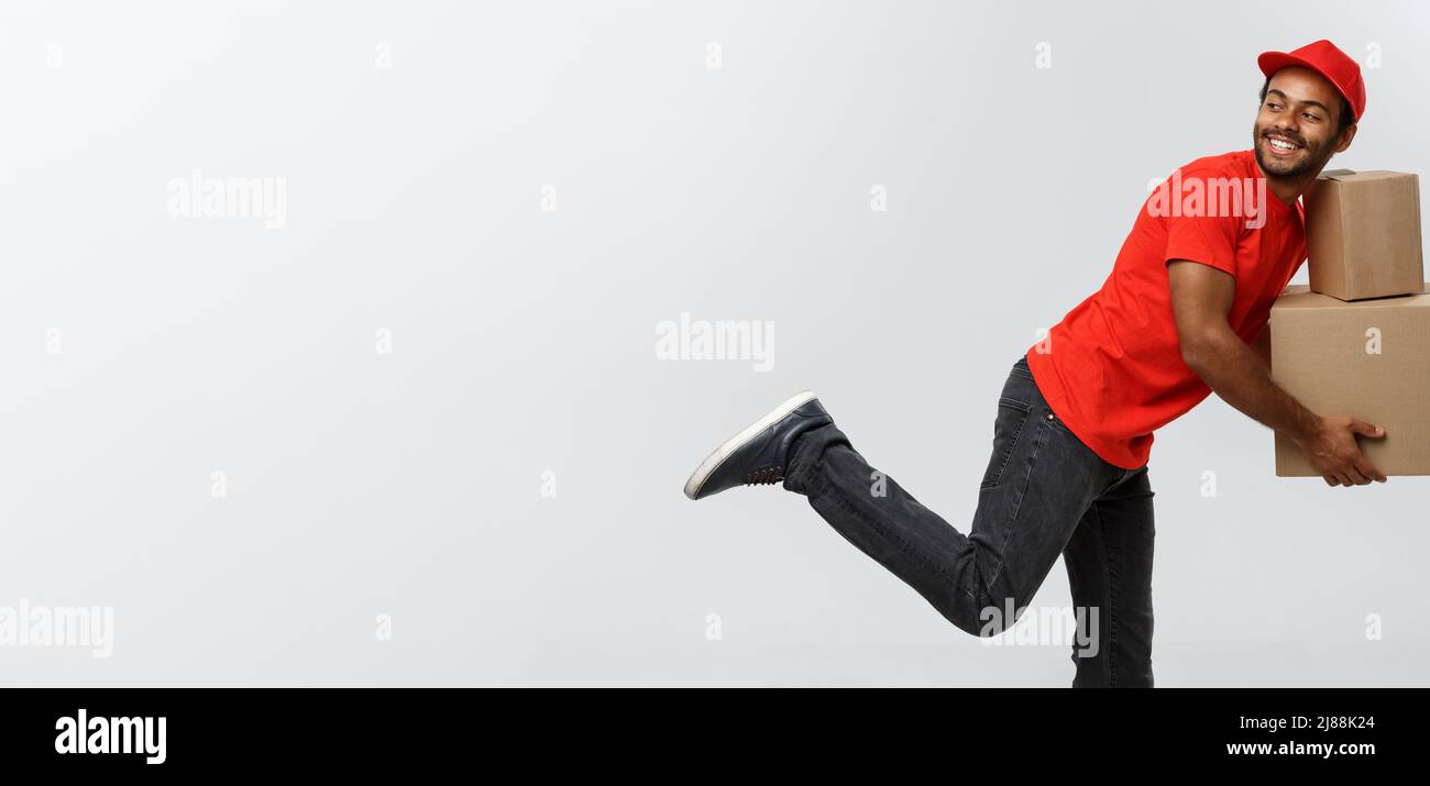 Delivery Concept - Handsome African American delivery man rush running ...