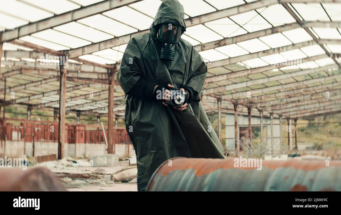 man with gas mask photographs the radioactive barrels Stock Photo - Alamy