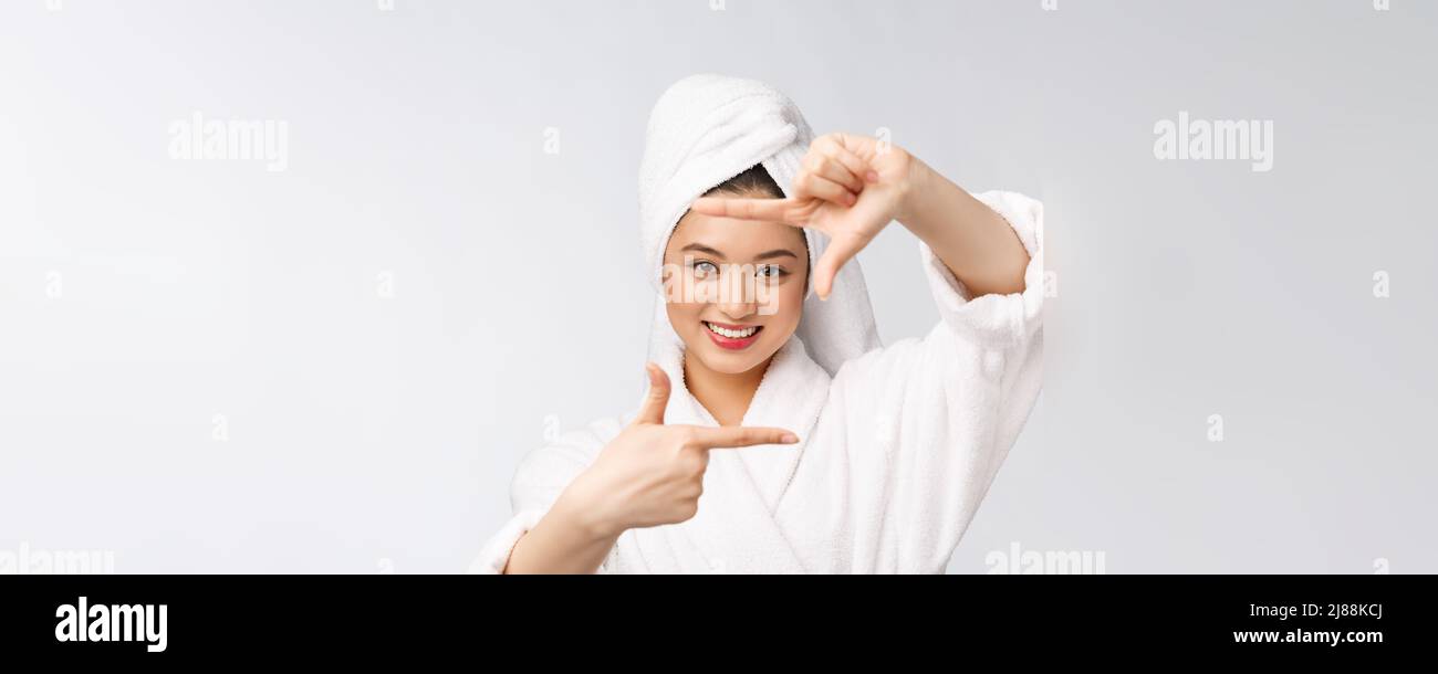 Beautiful Woman face and she making frame with hands with health skin ...