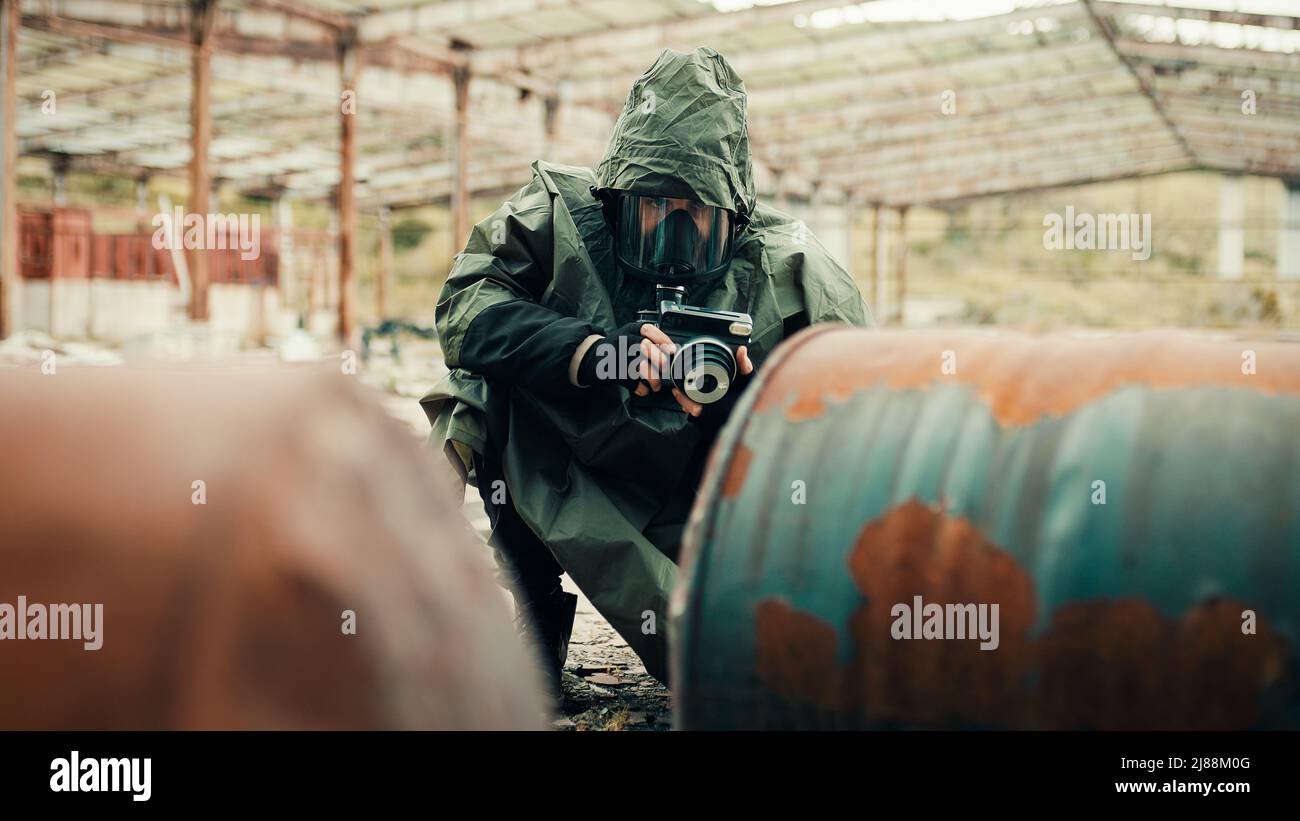 man with gas mask photographs the radioactive barrels Stock Photo - Alamy