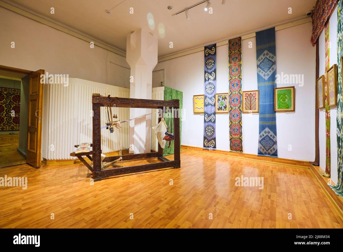 A gallery displaying ikat fabric and a weaving loom for ikat designs ...