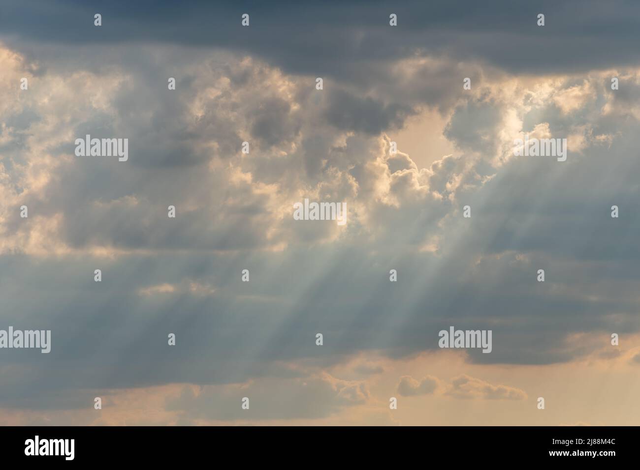 Sunshine through storm clouds in spring. Sunbeams in the sky Stock ...
