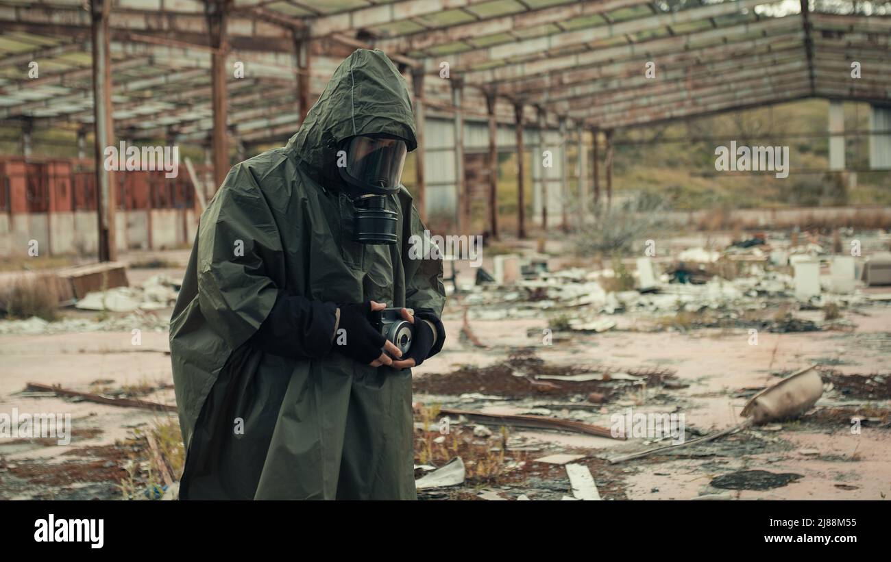 man with gas mask photographs the radioactive barrels Stock Photo - Alamy