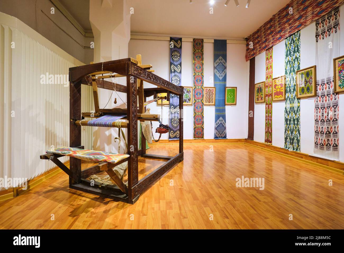 A gallery displaying ikat fabric and a weaving loom for ikat designs ...