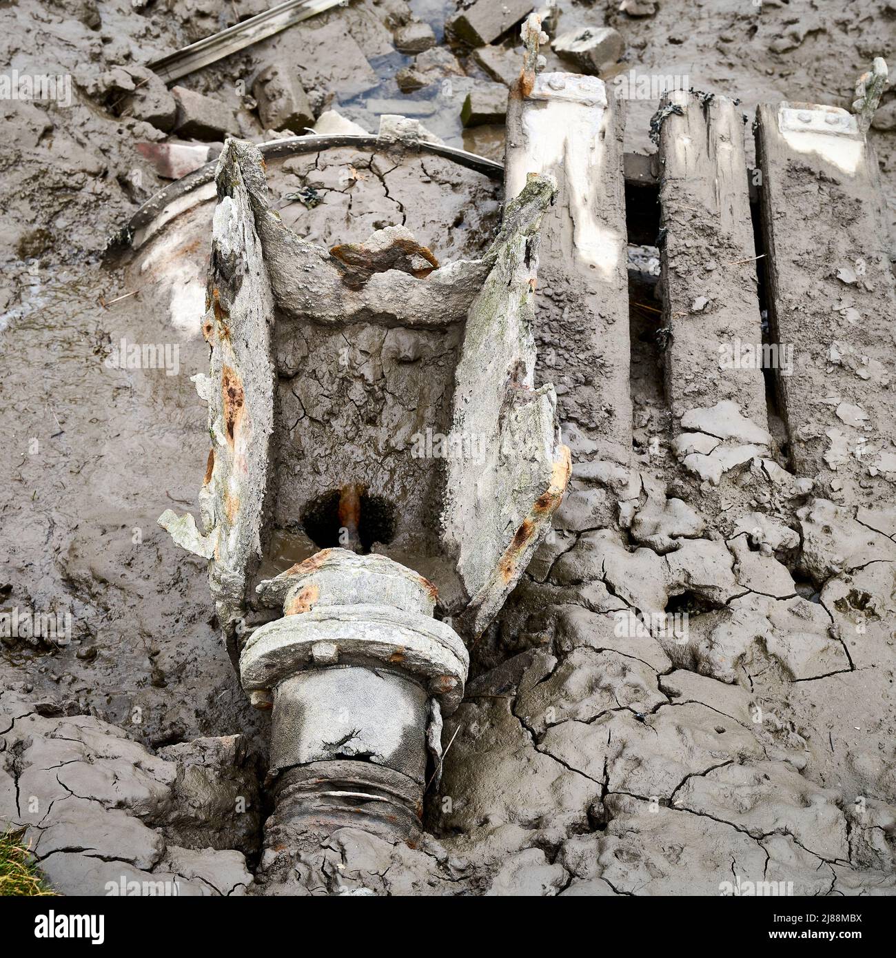 Old discharge pipe caked in river mud Stock Photo - Alamy