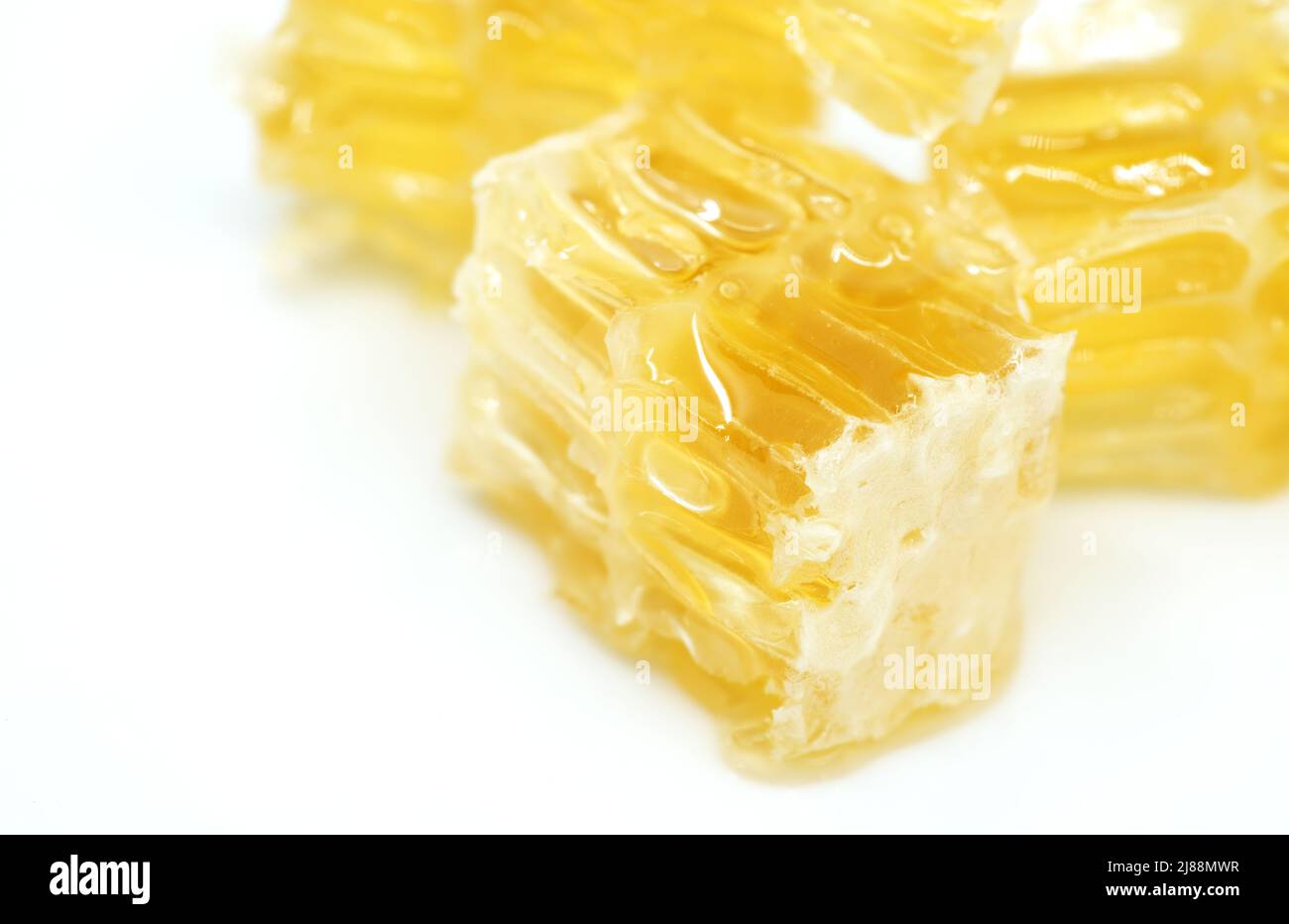 The macro small cube shape of honeycomb on white background, juicy ...