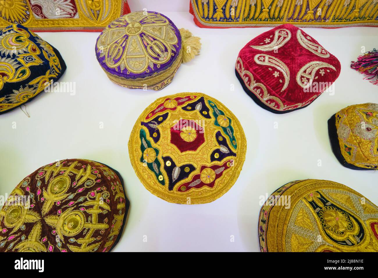 A display of various colorful Tubeteika style, traditional hats, caps ...