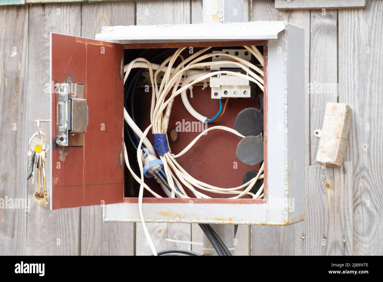 Open iron electrical panel in gray and brown with wires, switches and ...