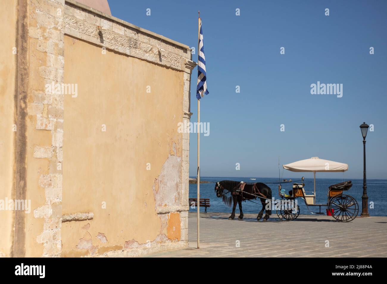 Chania, Greece. 11th May, 2022. A horse-drawn wagon is seen in the old port of Chania on the ...