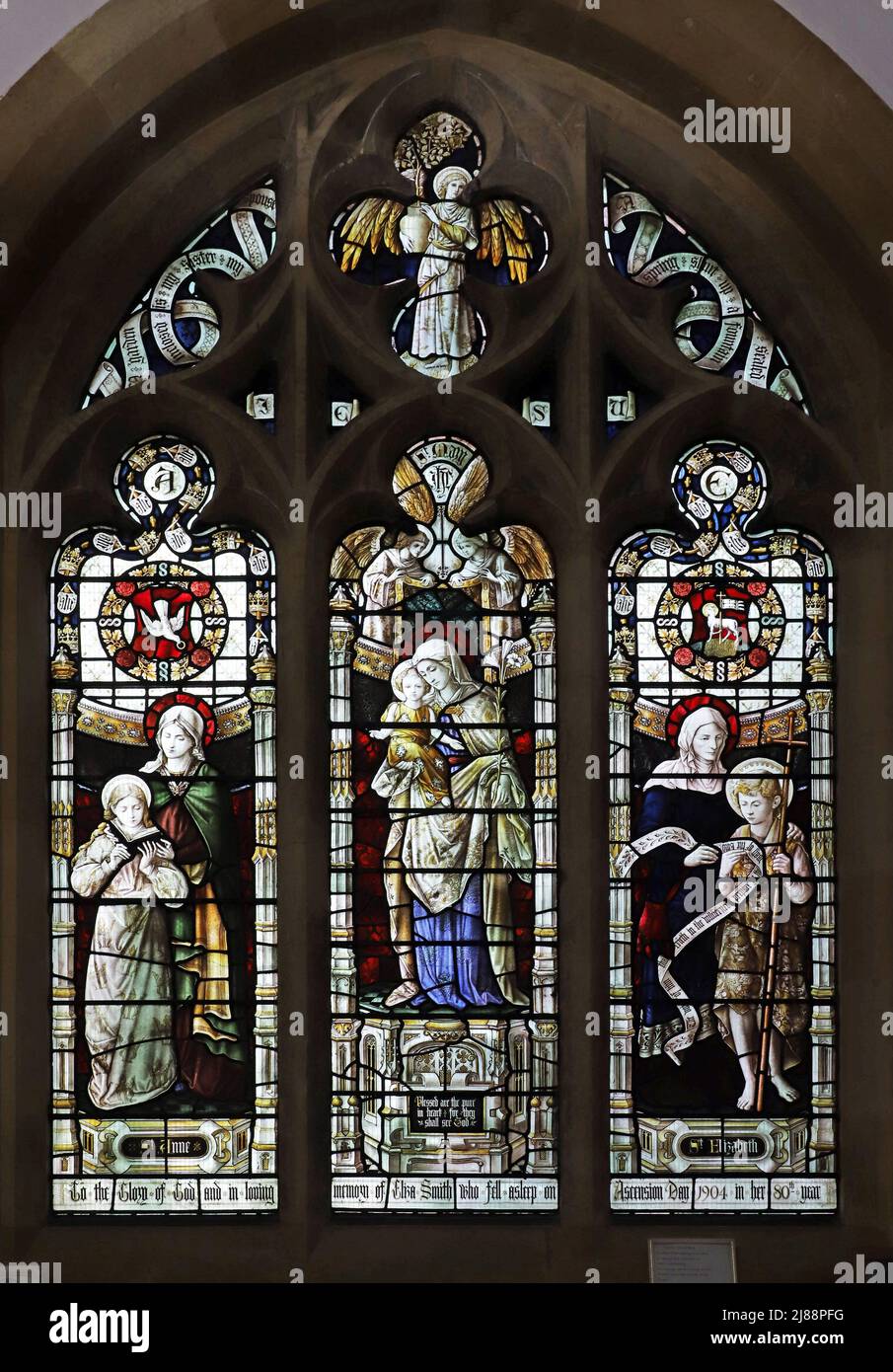 A stained glass window by Shrigley & Hunt depicting Ss Anne, Mary ...