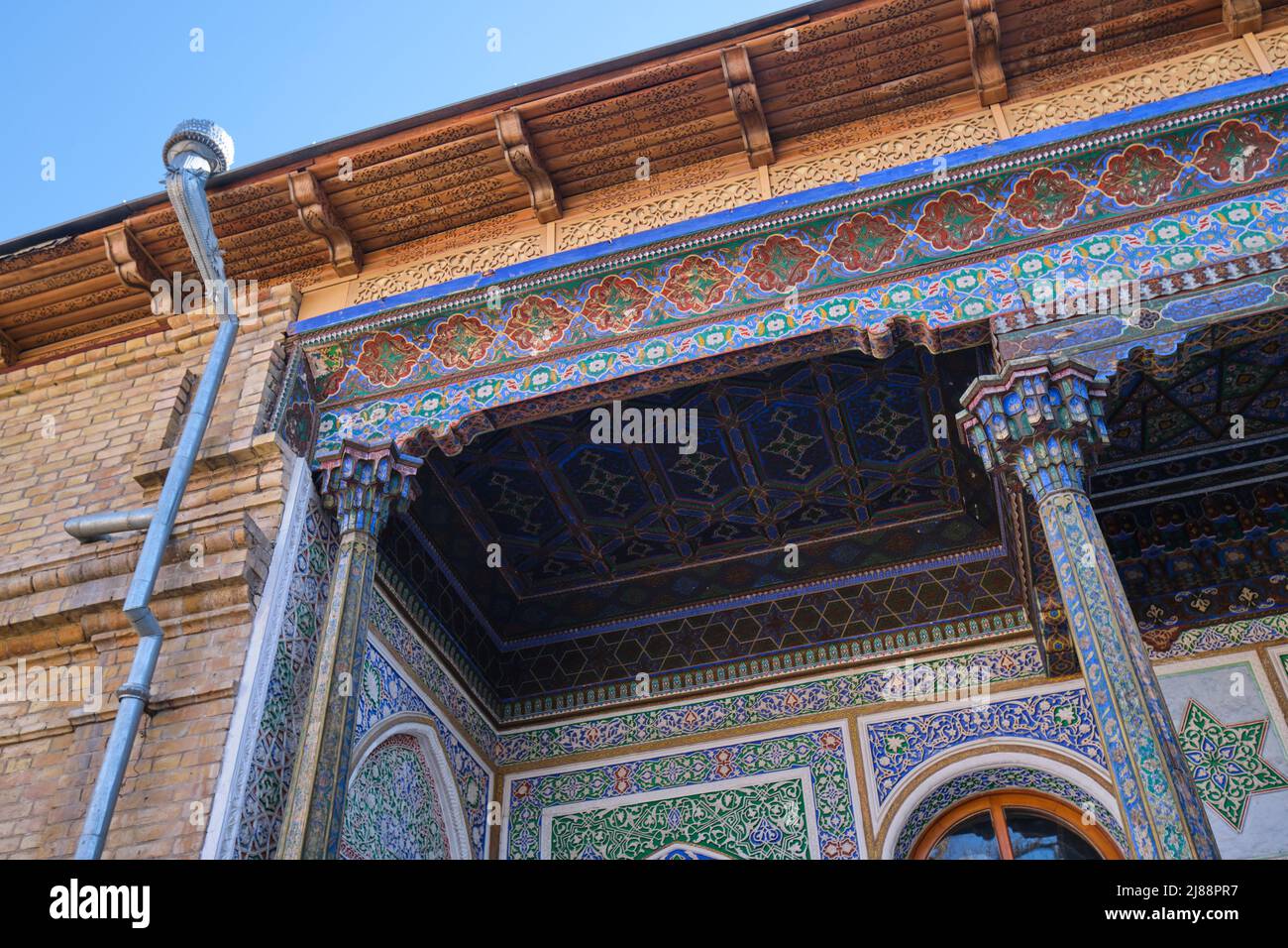View of a metal, tin downspout on the exterior facade of a richly ...