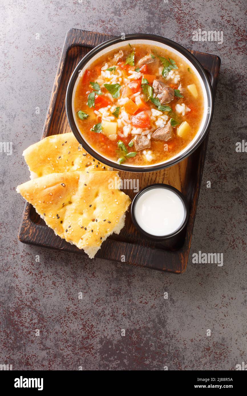 Spicy Uzbek mastava soup with lamb, rice and vegetables close-up in a ...