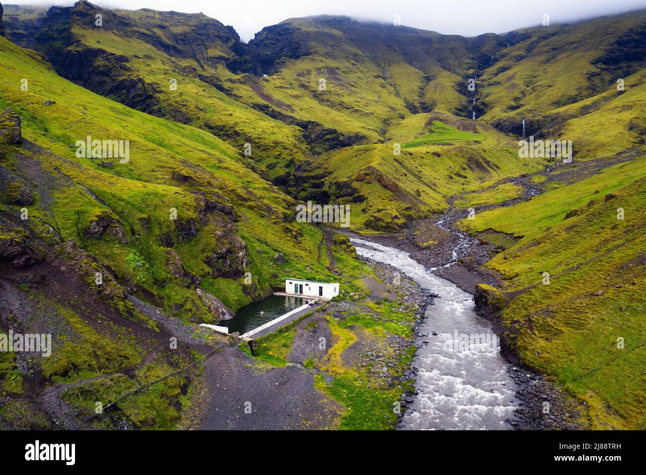 Aerial view of geothermal swimming pool Seljavallalaug in south Iceland ...