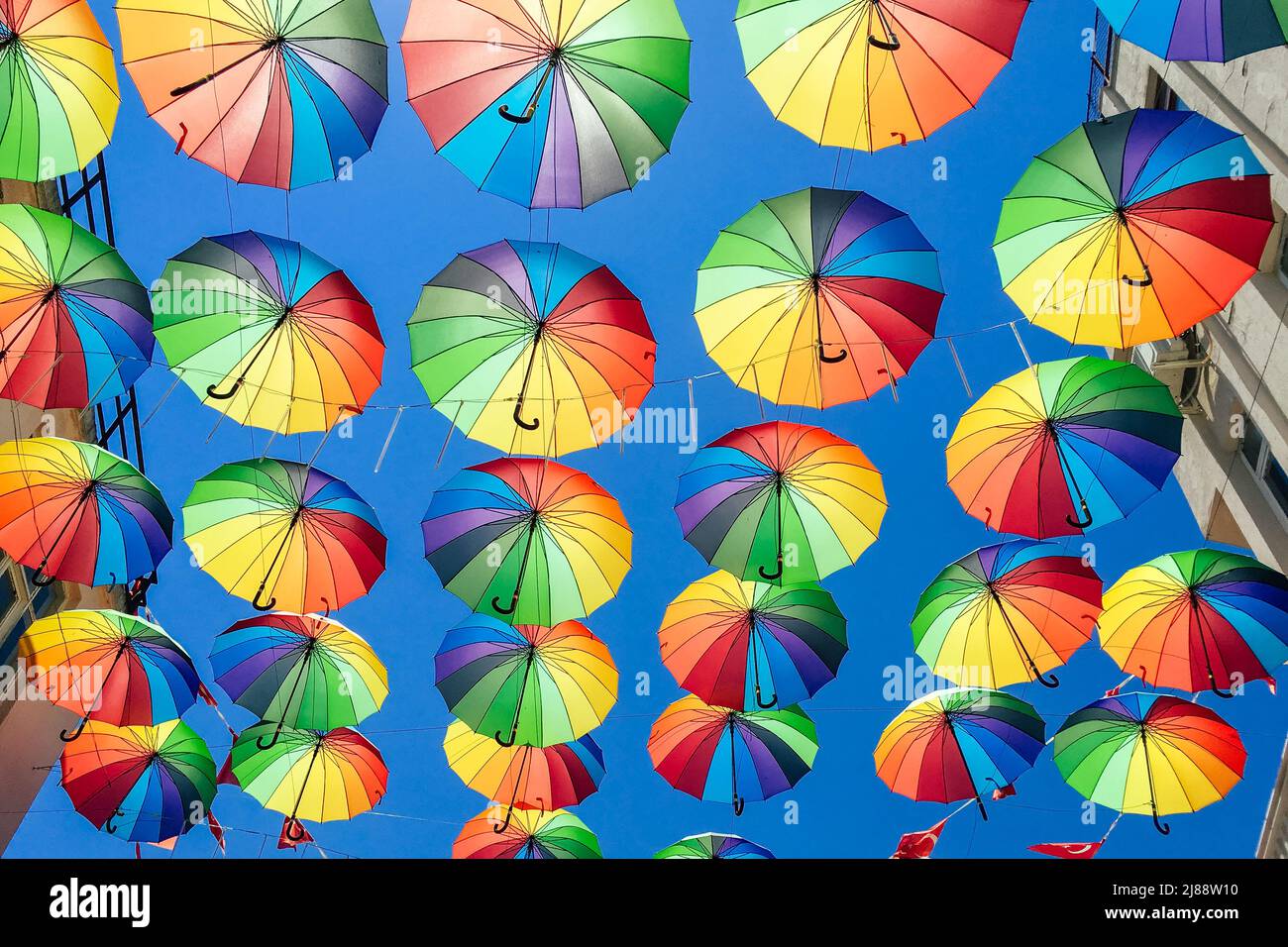 big blue Colorful umbrellas background on turkish sky Stock Photo - Alamy