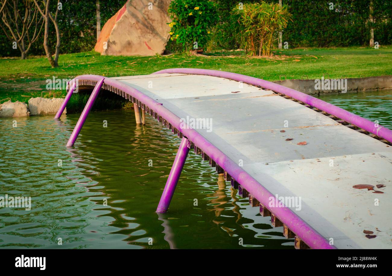 Cute little foot over bridge over artificial lake Stock Photo - Alamy