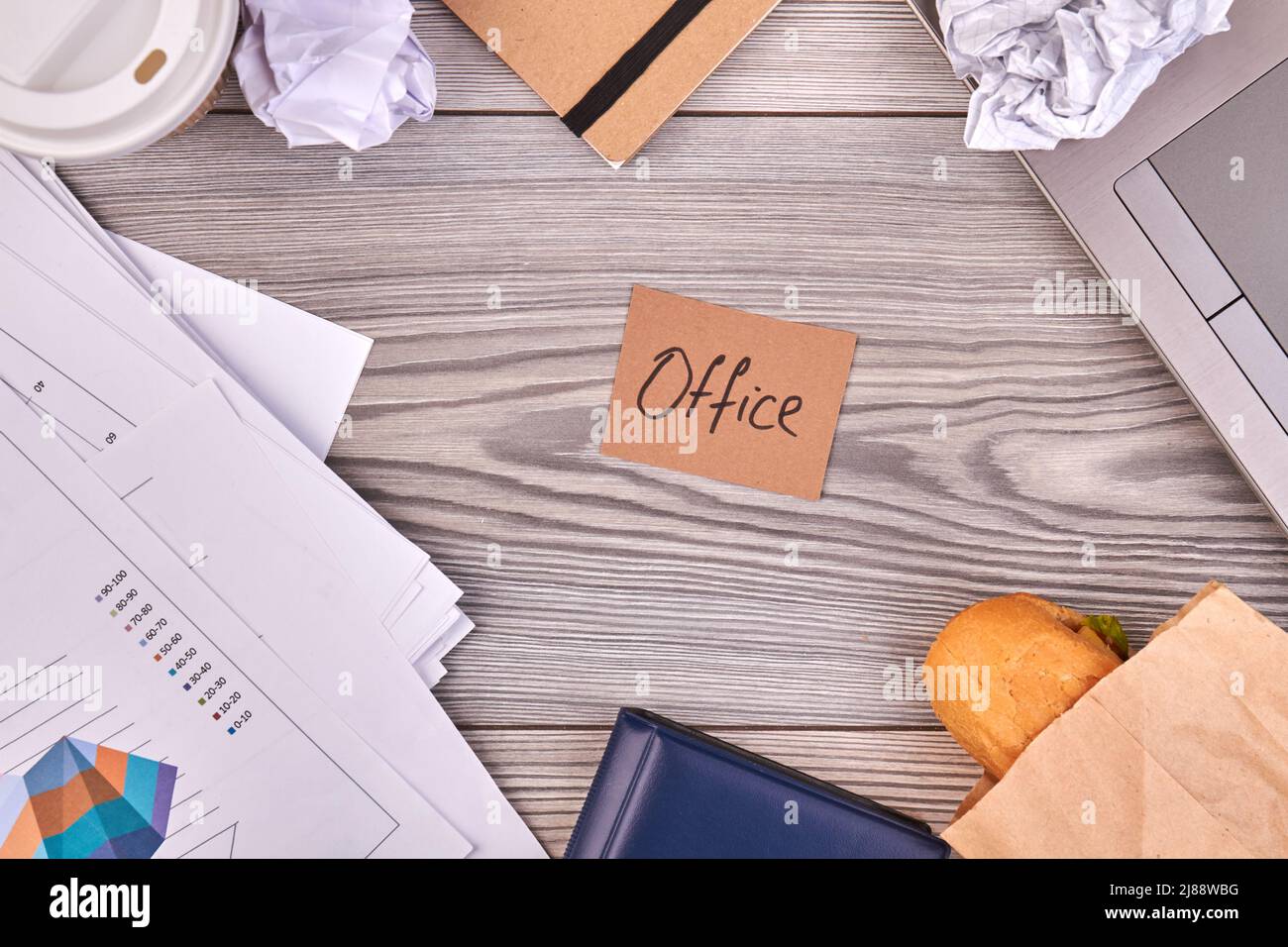 Top view flat lay office workers stuff on the desk. Handwritten word ...