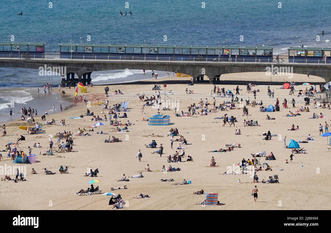 People enjoy the warm weather on Bournemouth Beach in Dorset ...