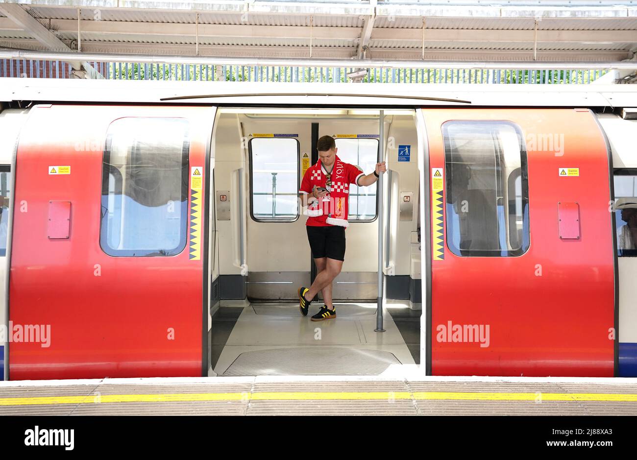 A Liverpool fan takes the London Underground tube to the stadium ahead ...
