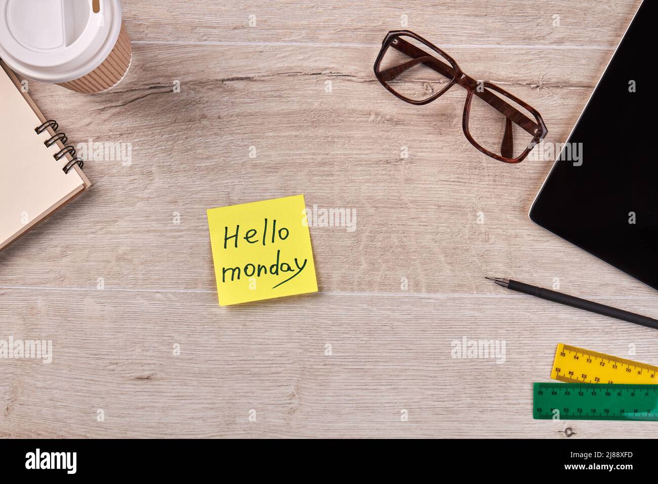 Hello monday handwriting with glasses and cup of coffee. Rulers and ...