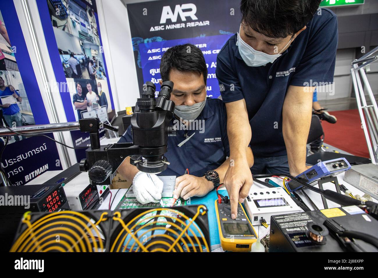 Bangkok, Thailand. 14th May, 2022. A staff member repair a miner ...