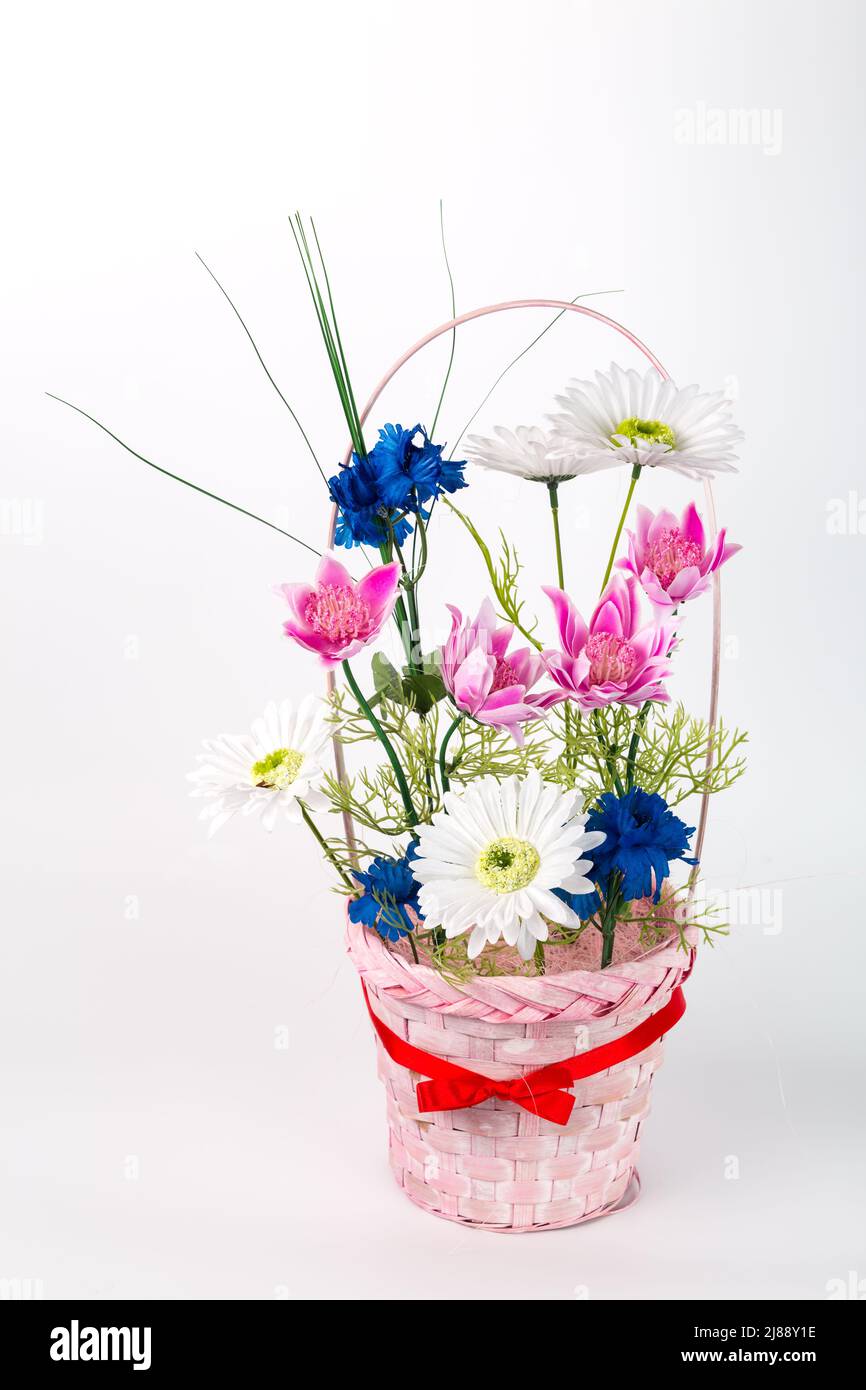 Composition with artificial flowers in a pot on white background ...