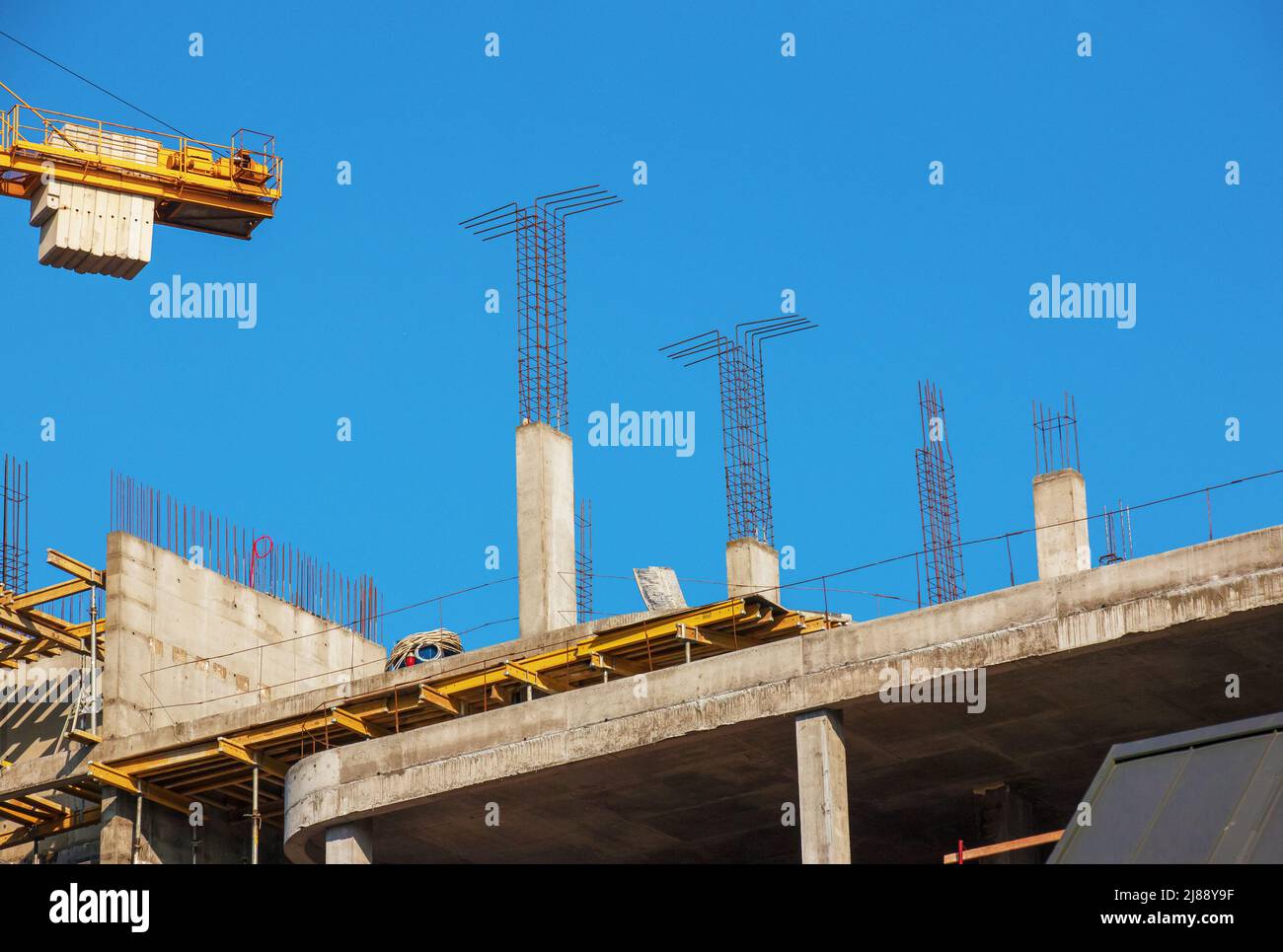A worker prepares formwork for a modern metal-concrete structure of a ...