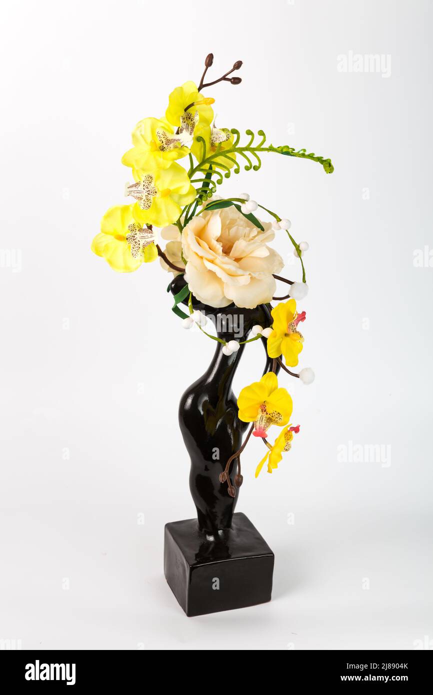 Composition with artificial flowers in a vase on white background ...